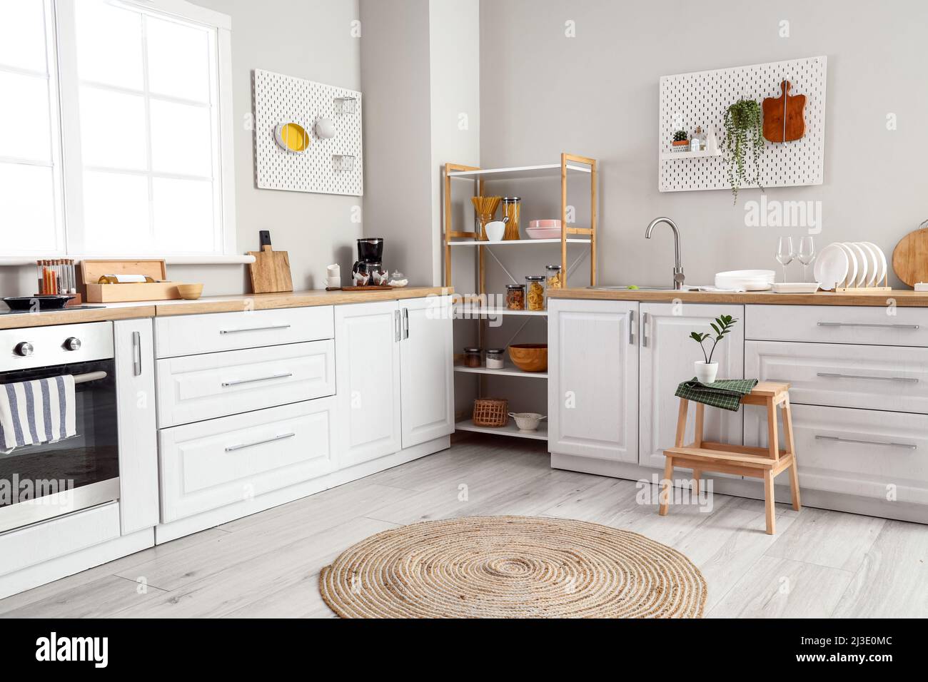Interior of modern kitchen with counters and shelving unit Stock Photo ...