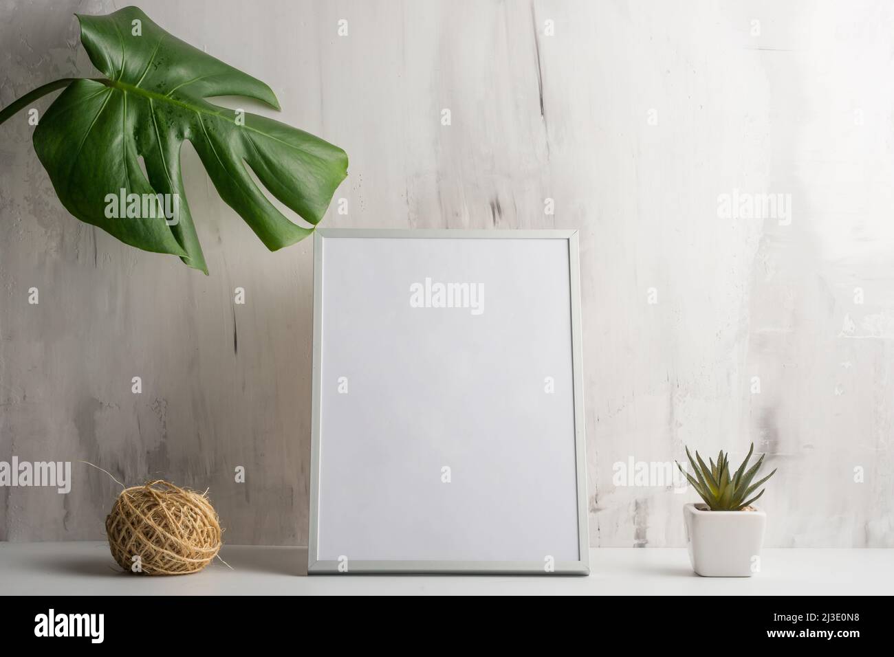 Empty white frame with flower on wall background. The concept of design ...