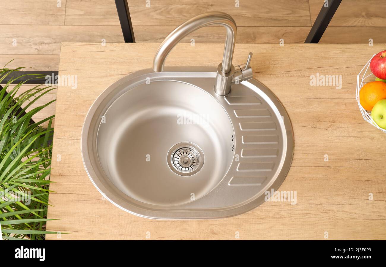 Wooden counter with sink in modern kitchen Stock Photo - Alamy