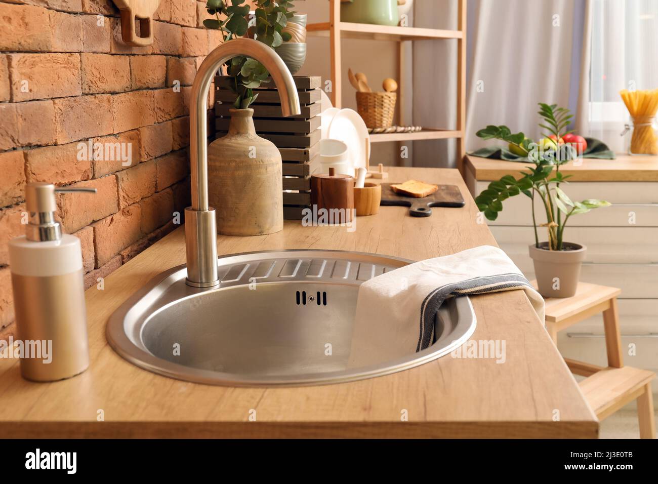 Wooden counter with sink in modern kitchen Stock Photo - Alamy
