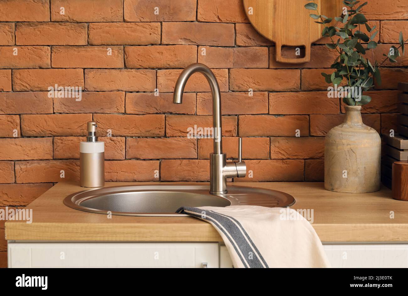 Wooden counter with sink near brick wall Stock Photo - Alamy