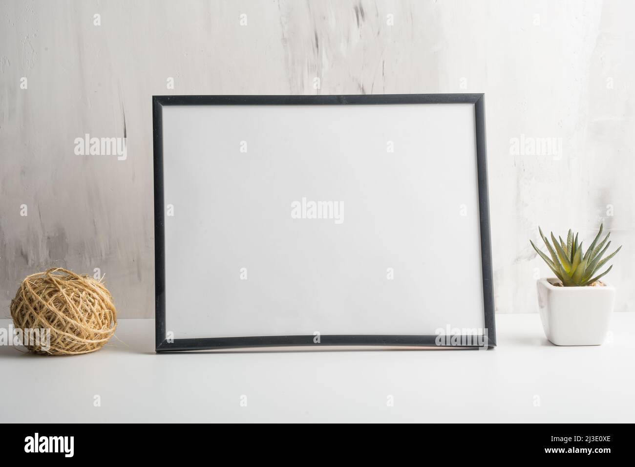 Empty white frame with flower on wall background. The concept of design ...