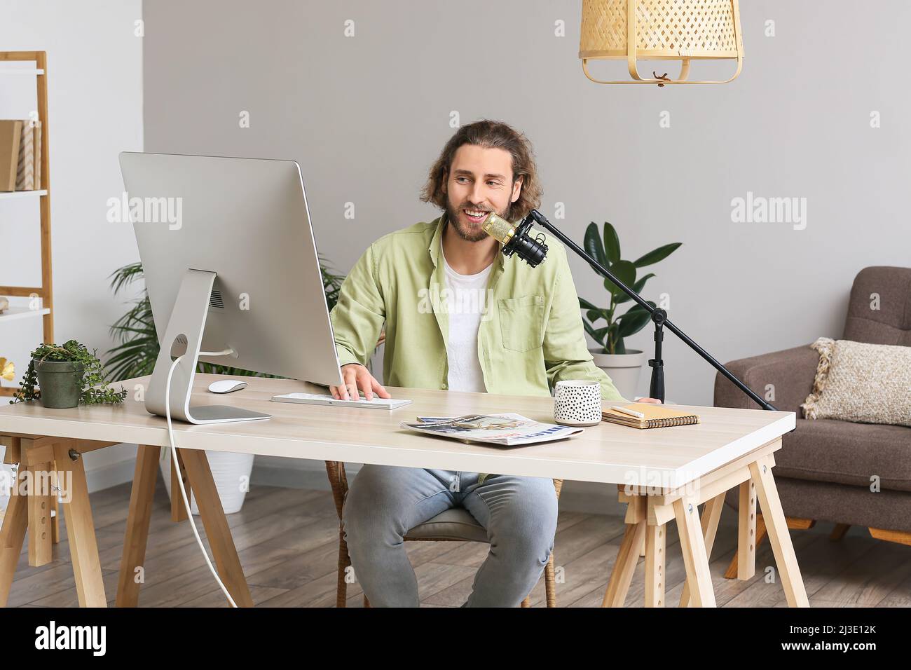 Streamer recording podcast using microphone hi-res stock photography ...
