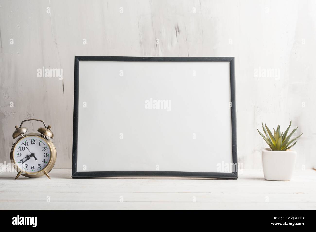 Empty white frame with flower on wall background. The concept of design ...
