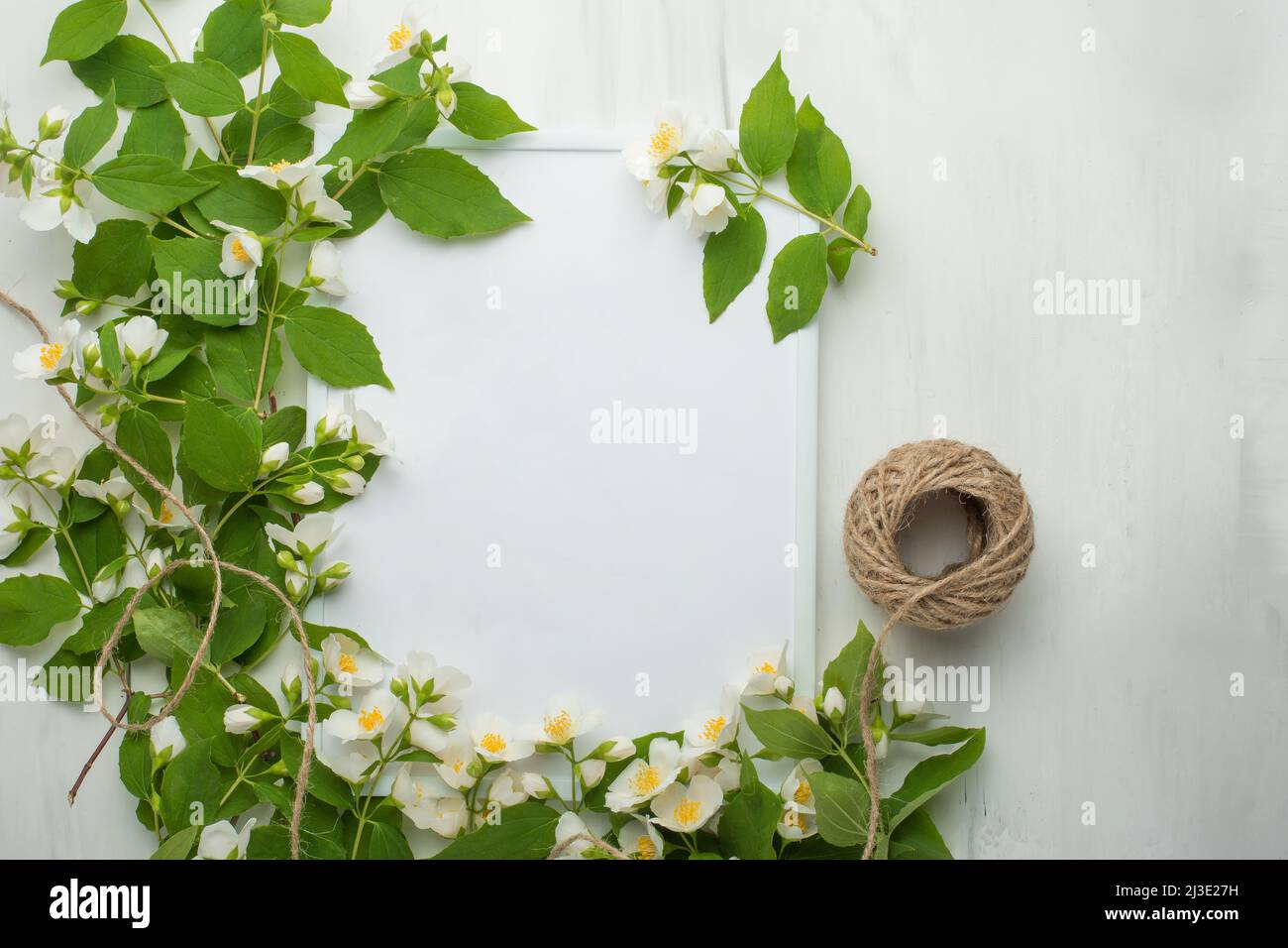 Empty frame with flowers on a light background. It is possible to use ...