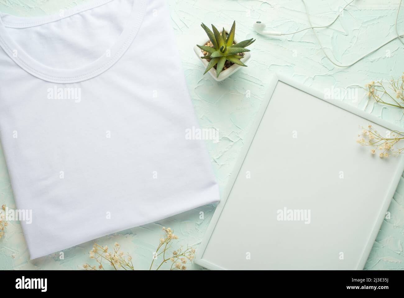 An empty folded T-shirt with a frame on a light background, for a ...