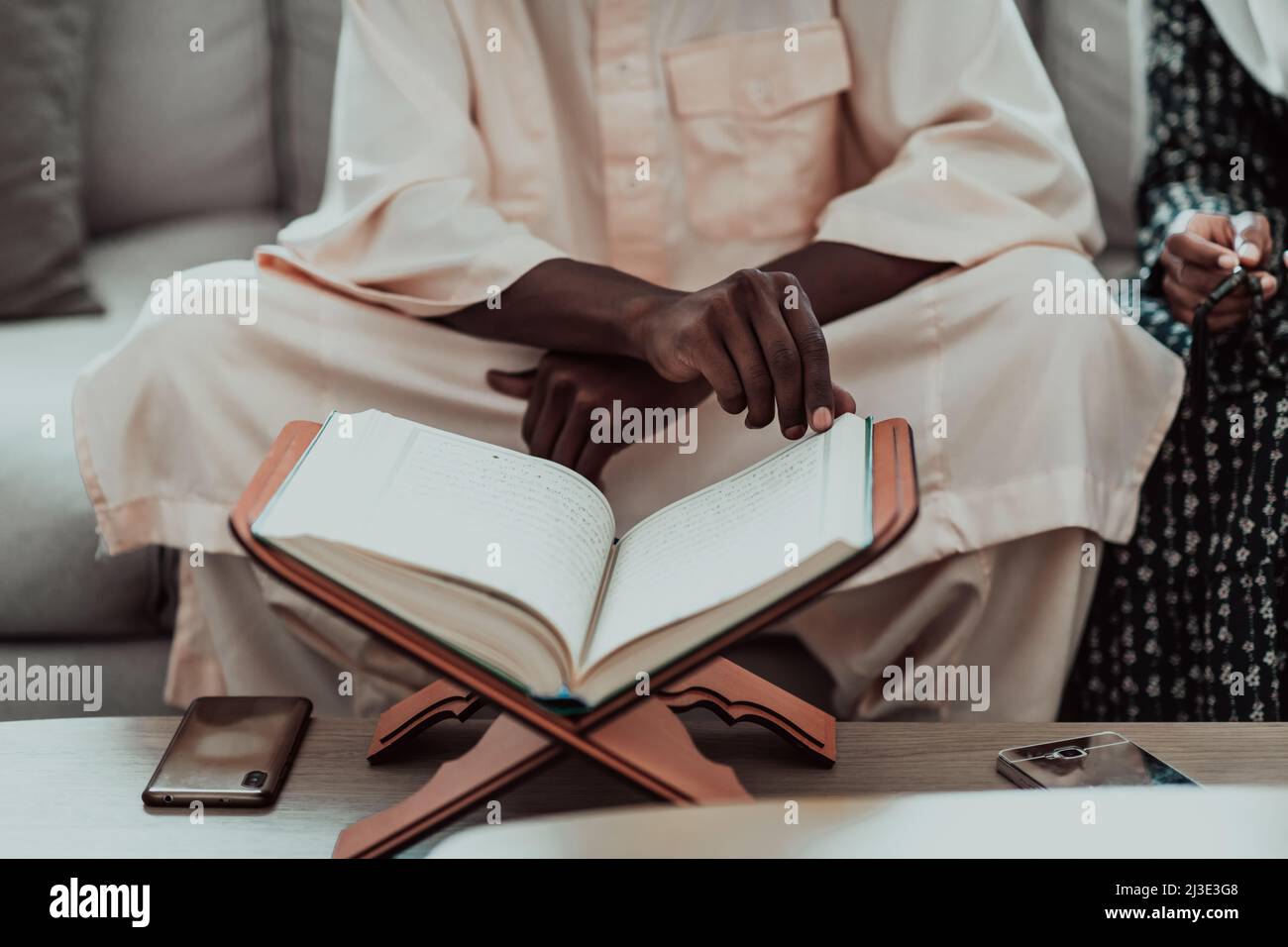 African Muslim couple at home in Ramadan reading Quran holly Islam book ...