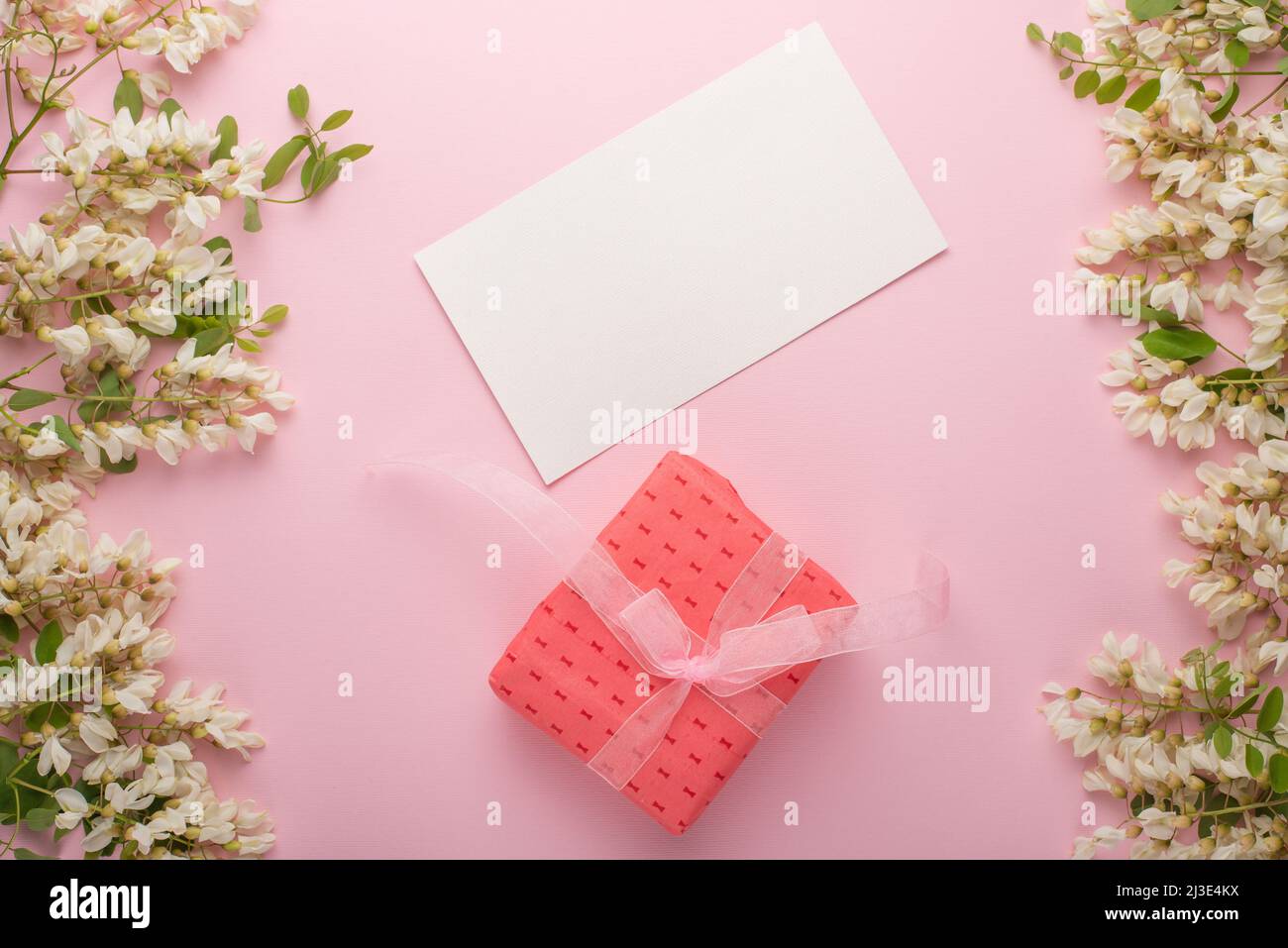 Spring floral background with gift, texture and wallpaper. Flat white ...