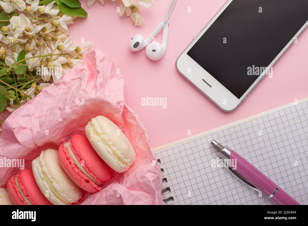 Macaroni in a box on a light pink background with white flowers ...