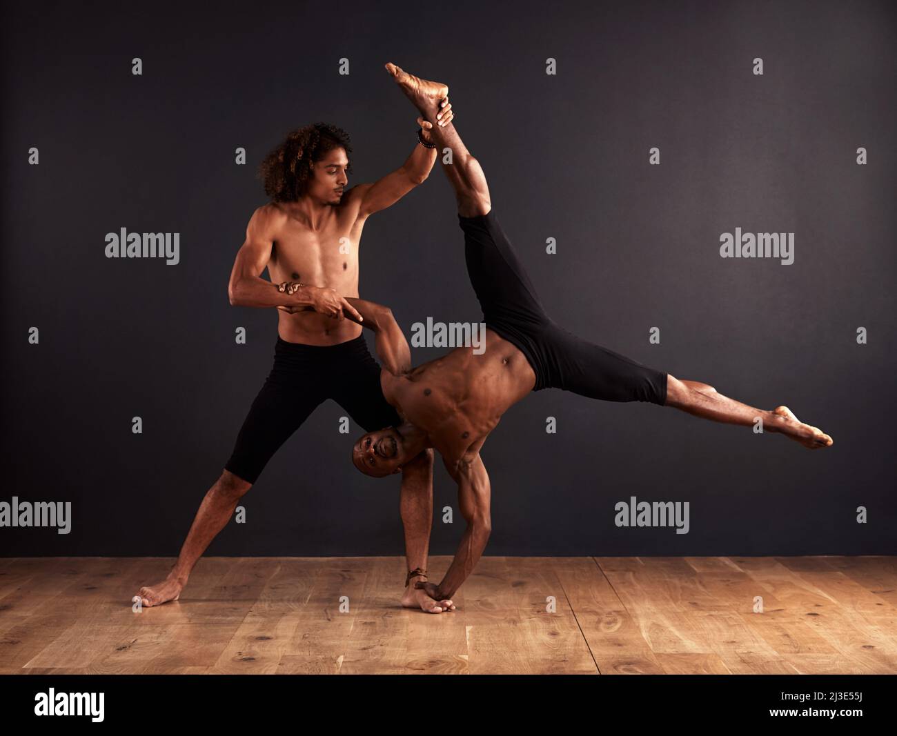 Trust and strength. Two male contemporary dancers performing a dramatic ...