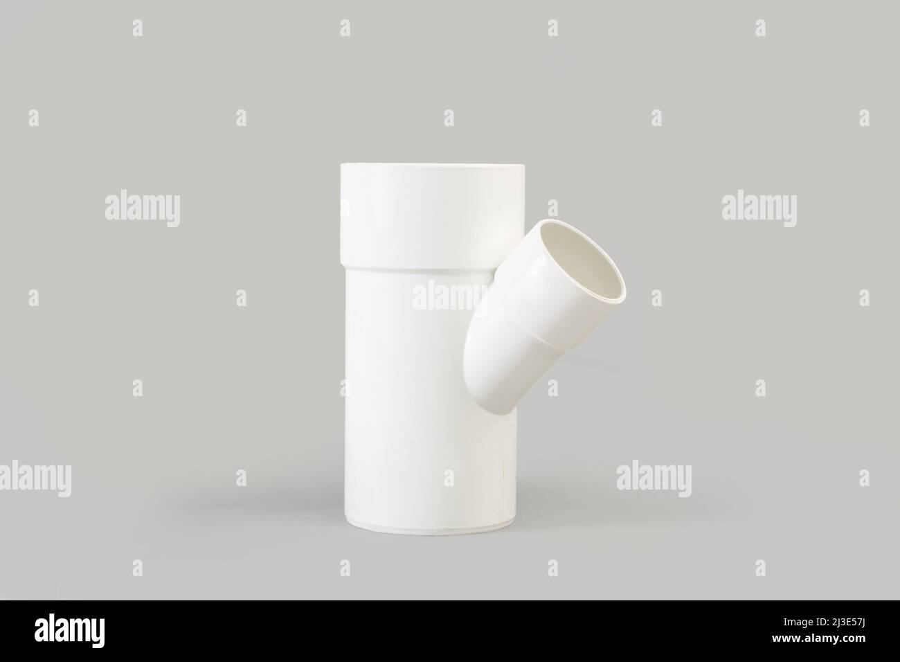 White plastic connection pipe on a gray background with copy space ...