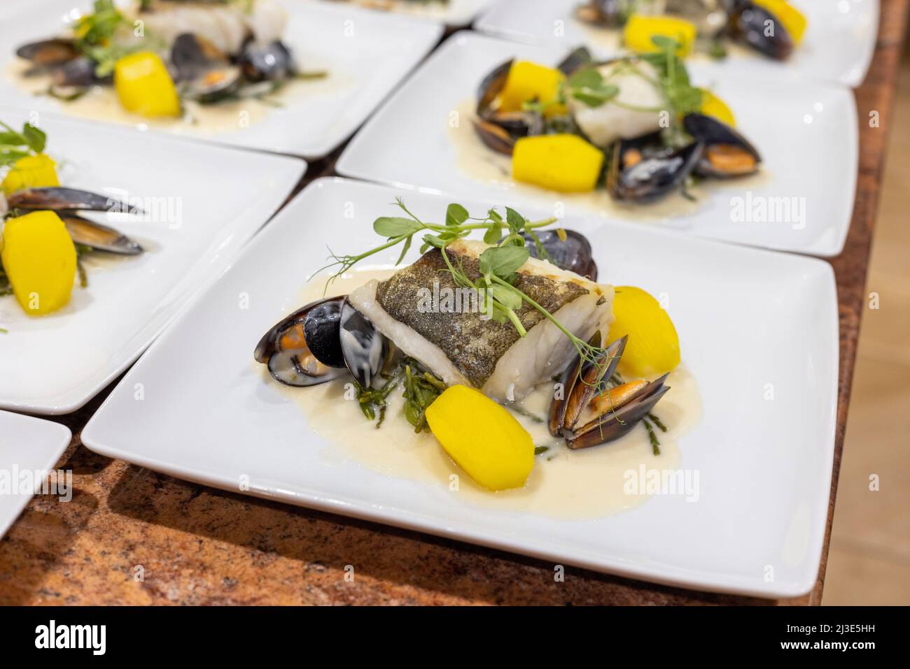 Plated up food waiting to be served from a commercial kitchen for an ...