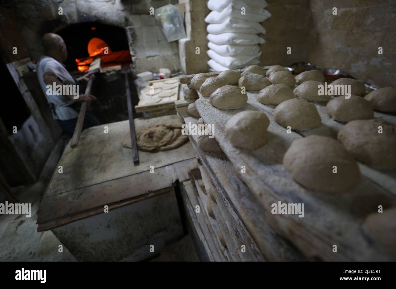 Nablus. 7th Apr, 2022. A Palestinian baker uses a traditional wood ...