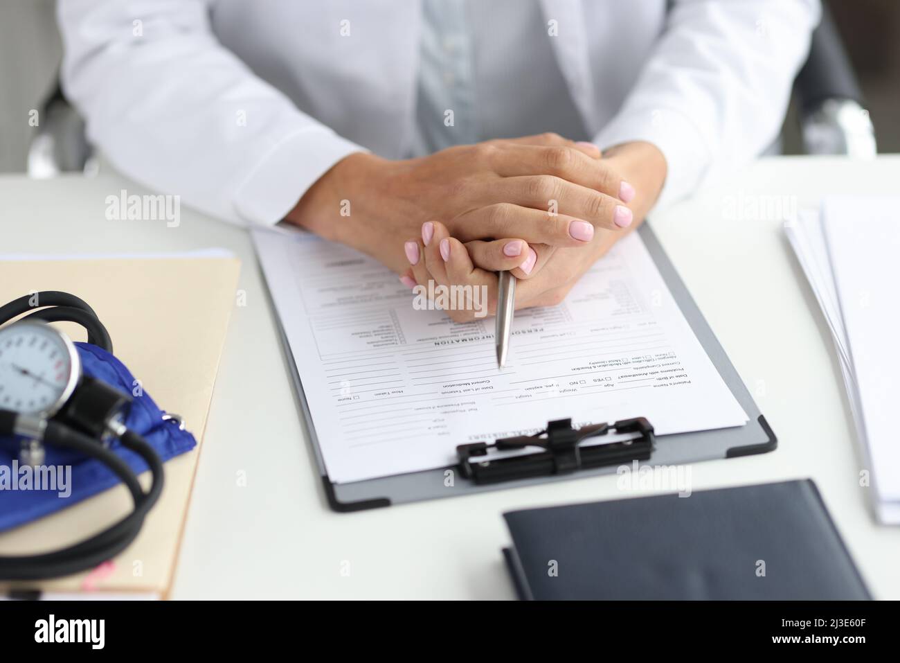 Doctor holds pen and medical record at workplace closeup Stock Photo ...