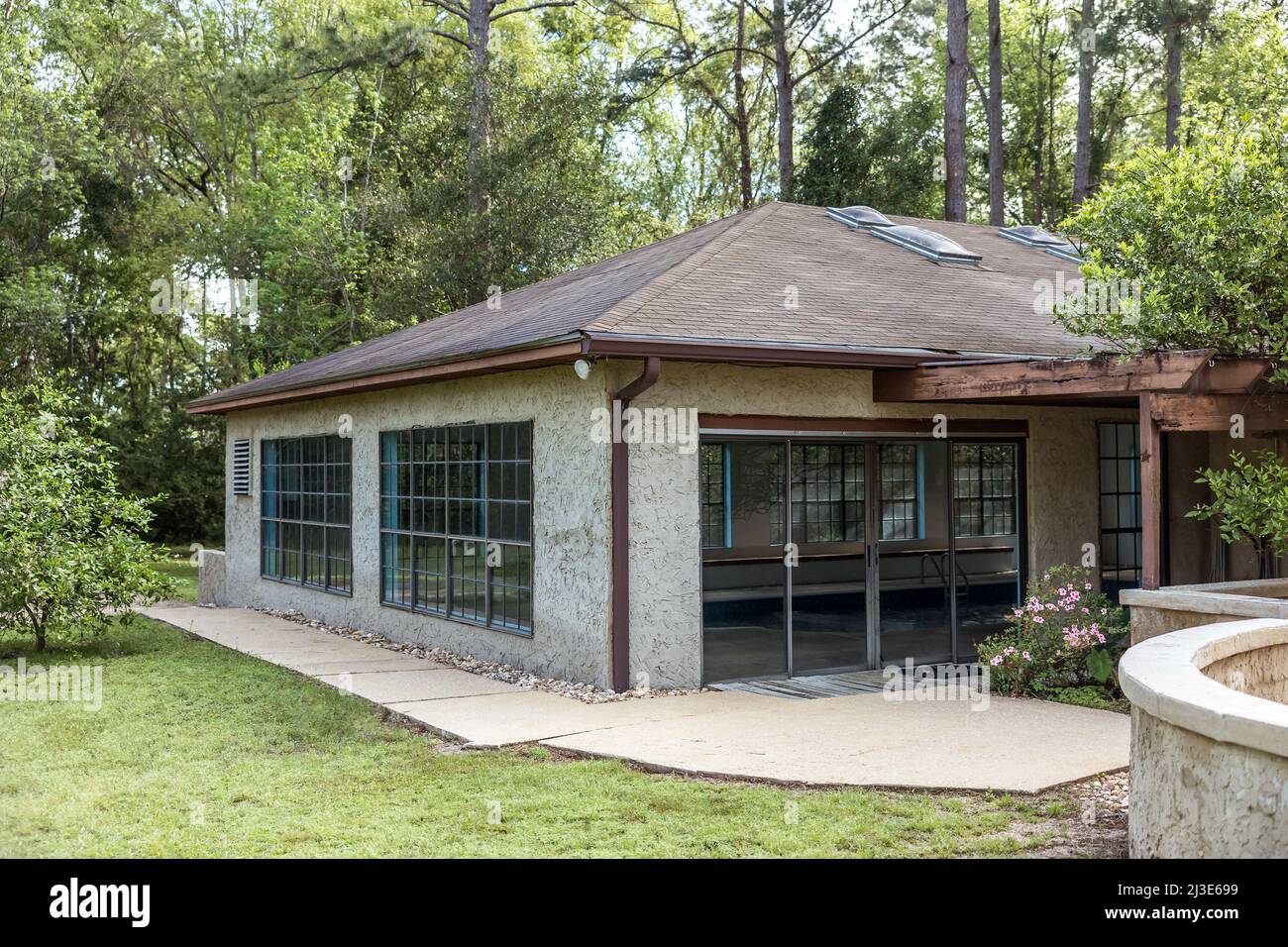 Rear side view of brown spanish style stucco and cinder block 1970's ...