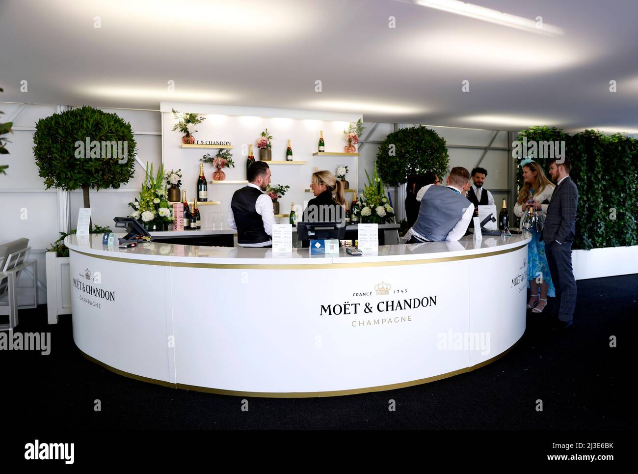 Racegoers visit the Moet & Chandon champagne bar at Aintree Racecourse ...