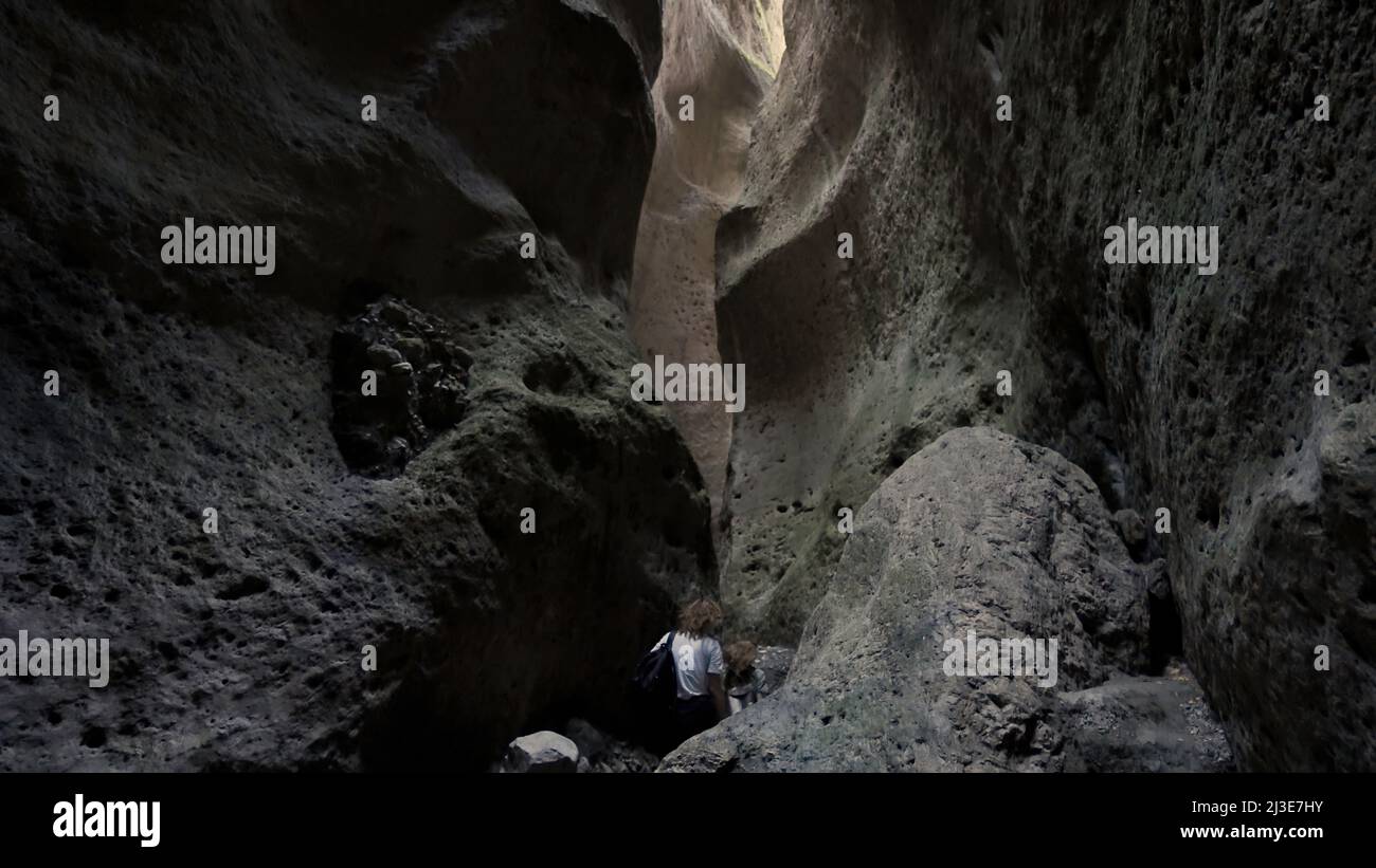 A walk inside the mountain. Action. People walk inside the mountain ...