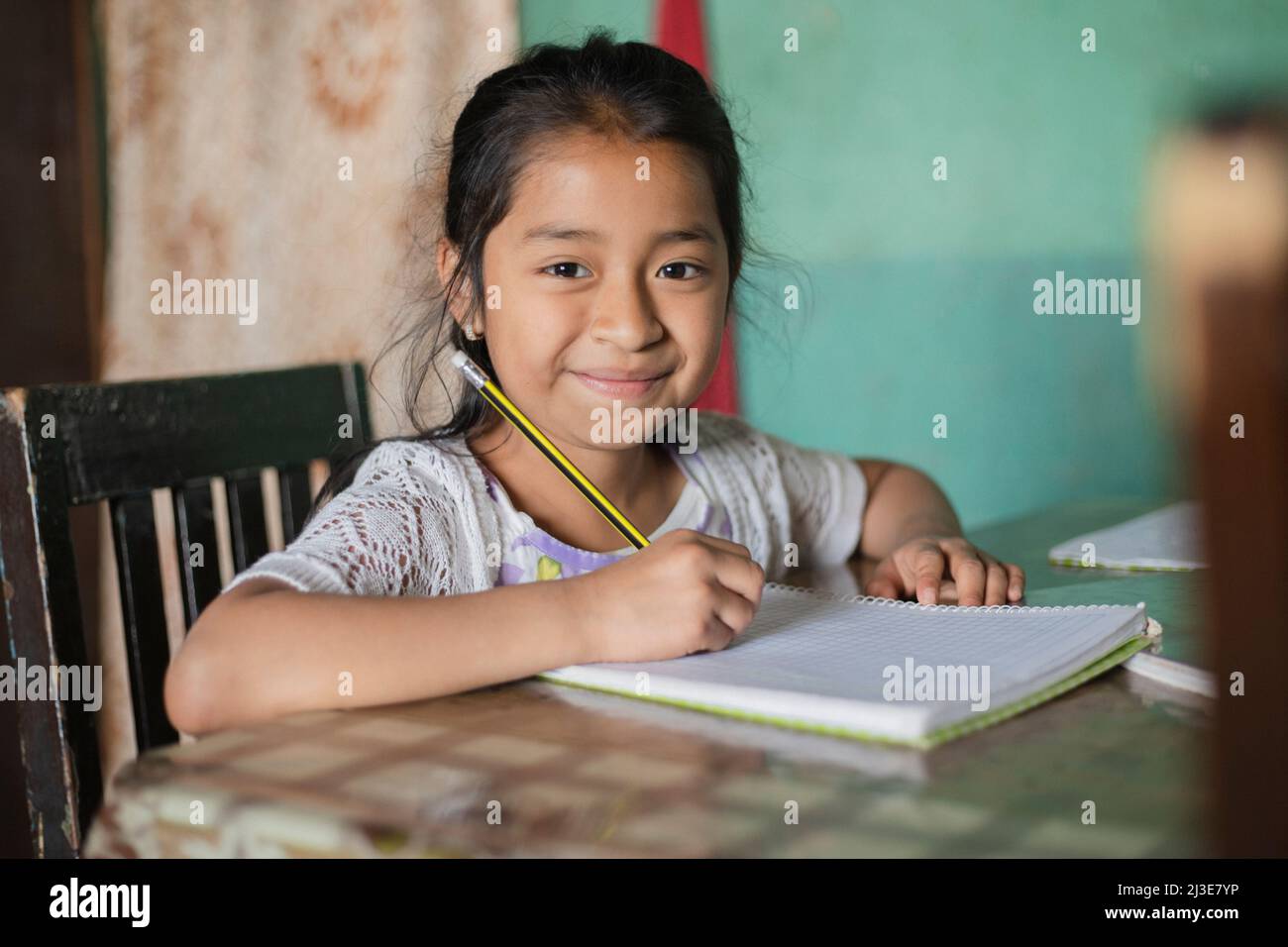 Hispanic girl doing homework at home in rural area - Mayan girl ...