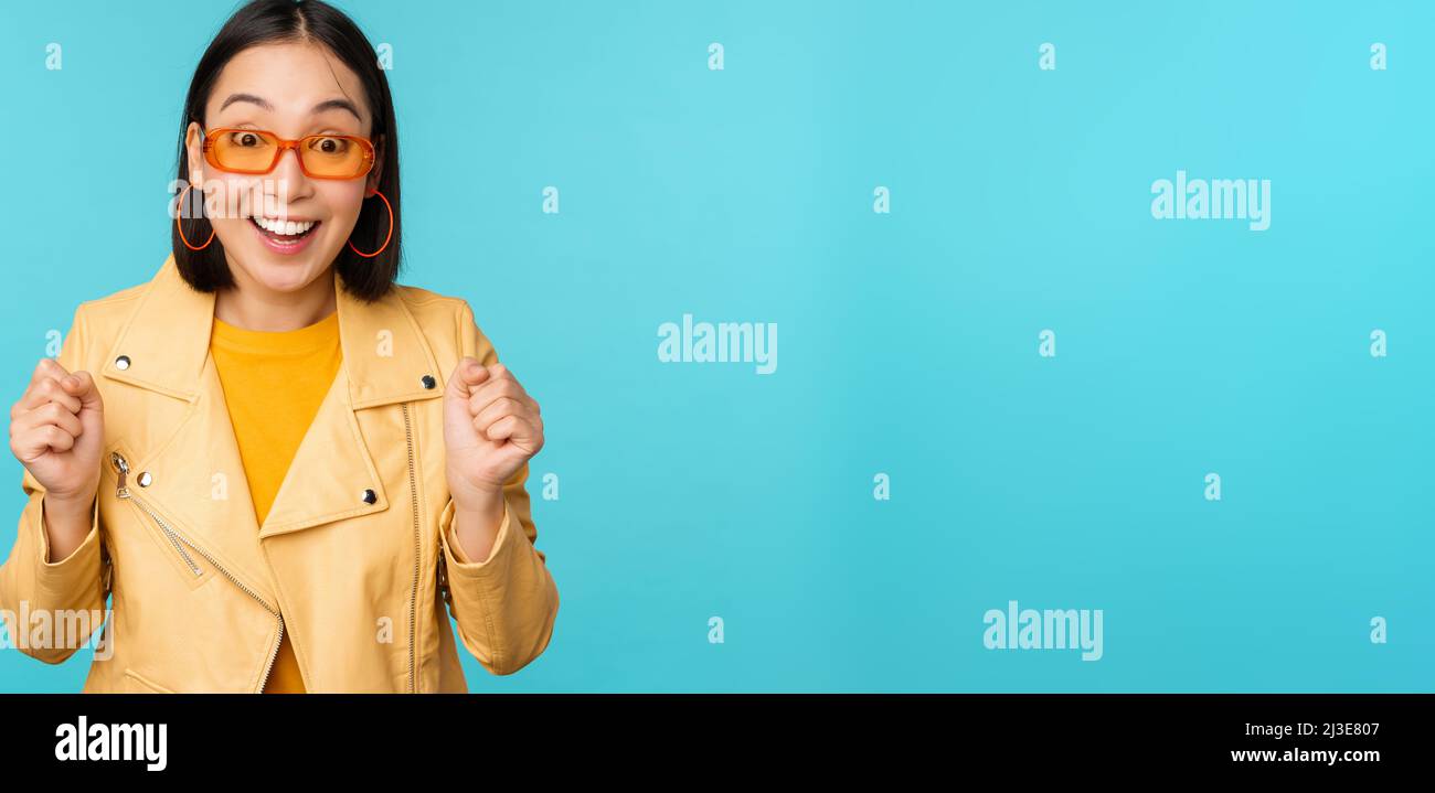 Image of enthusiastic young asian woman celebrating, triumphing ...