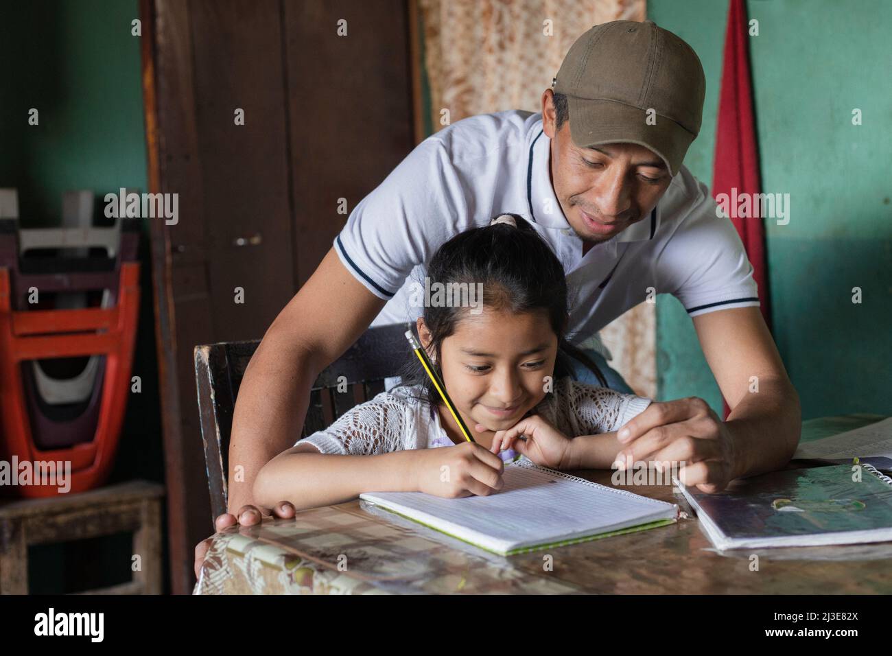 Hispanic dad helping his little daughter do her homework - Teacher ...