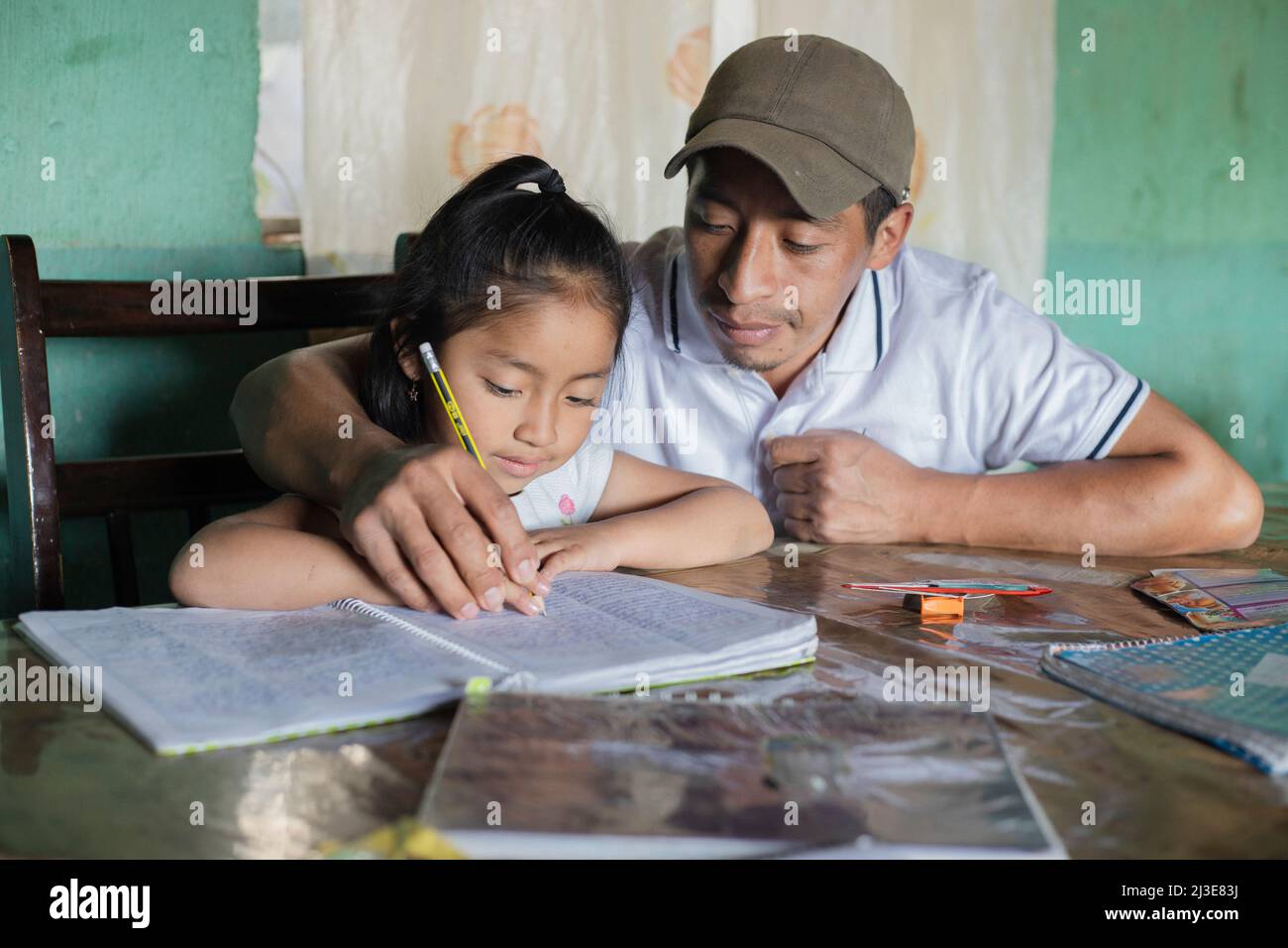 Hispanic dad helping his little daughter do her homework - Teacher ...