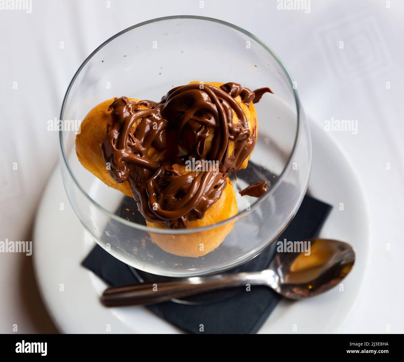 Cream profiteroles with hot chocolate Stock Photo - Alamy