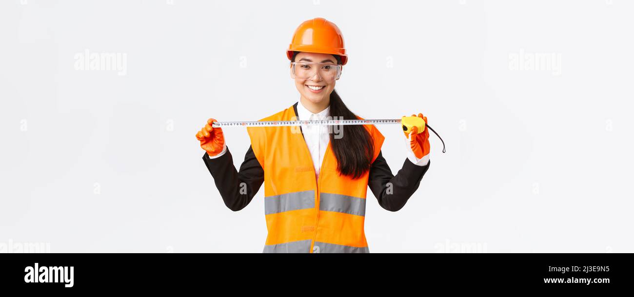 Confident professional female asian architect measuring layout, wearing ...