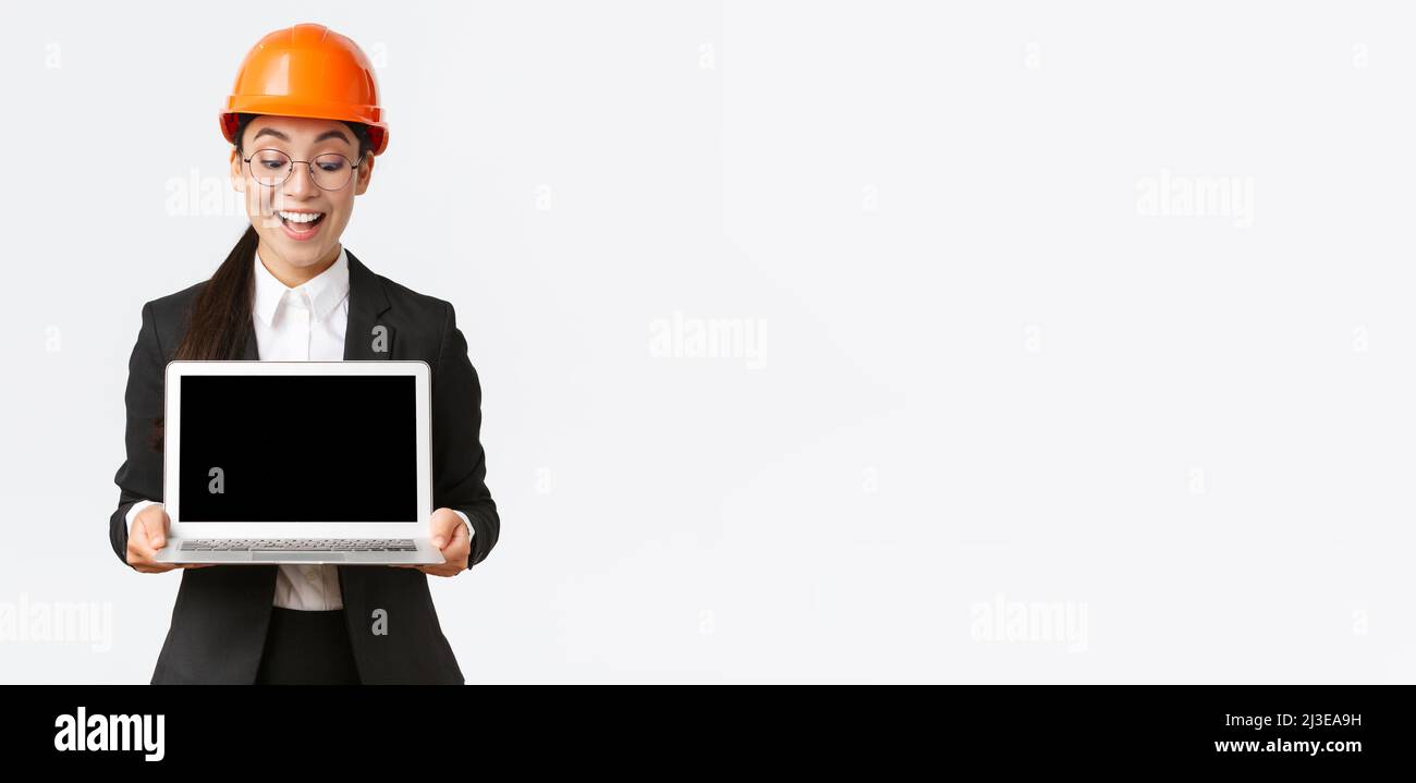 Impressed happy asian female chief engineer showing great results of ...