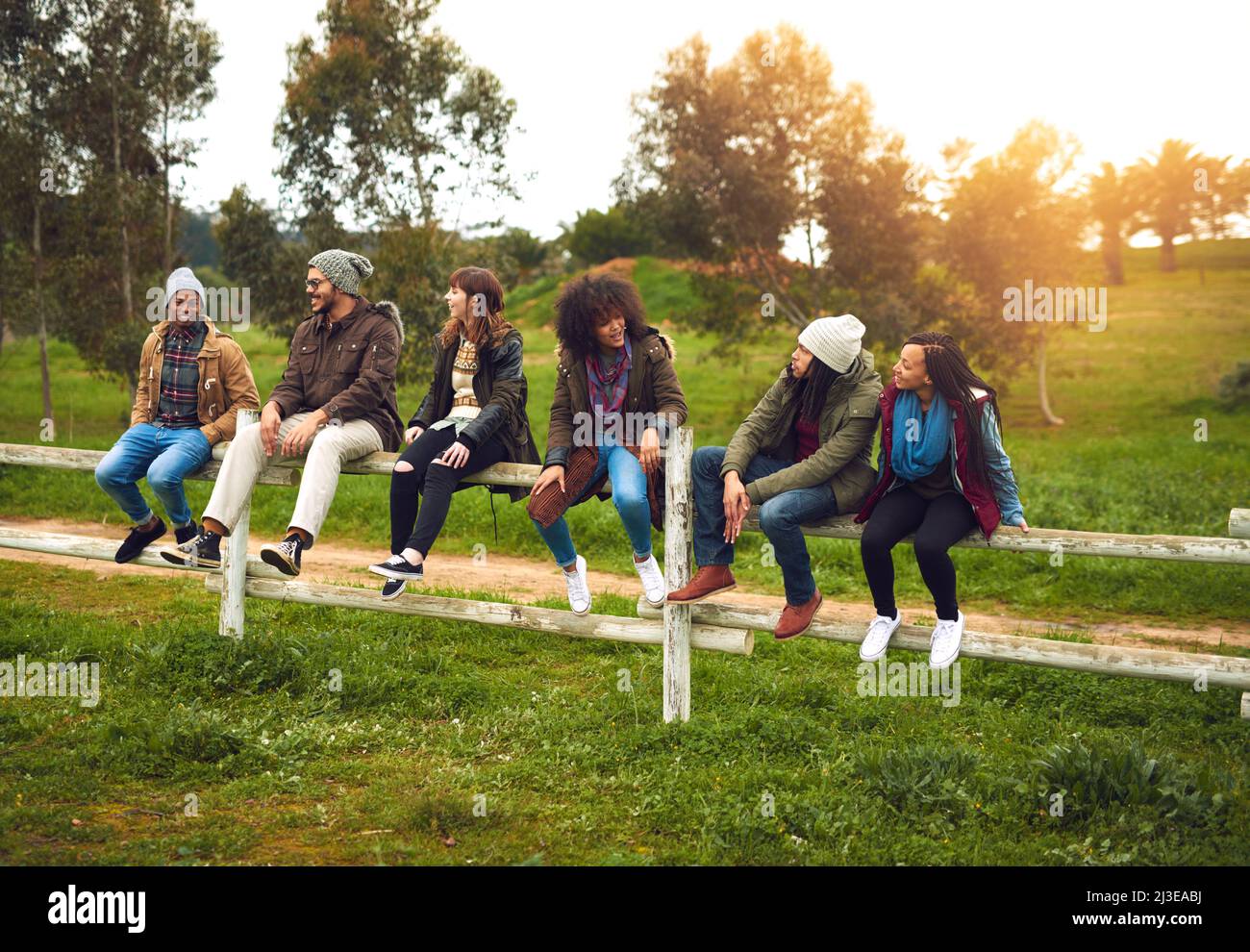 Friends sitting on fence hi-res stock photography and images - Alamy