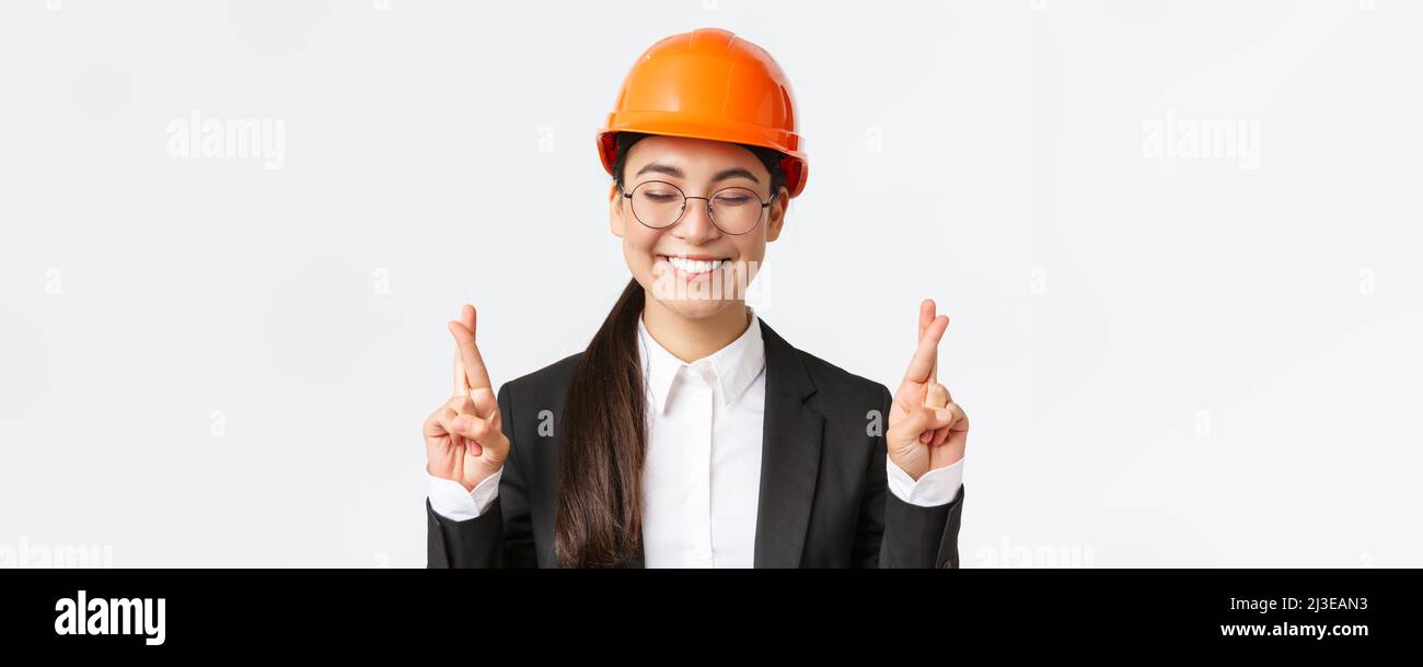 Close-up of hopeful optimistic asian female engineer, architect having ...