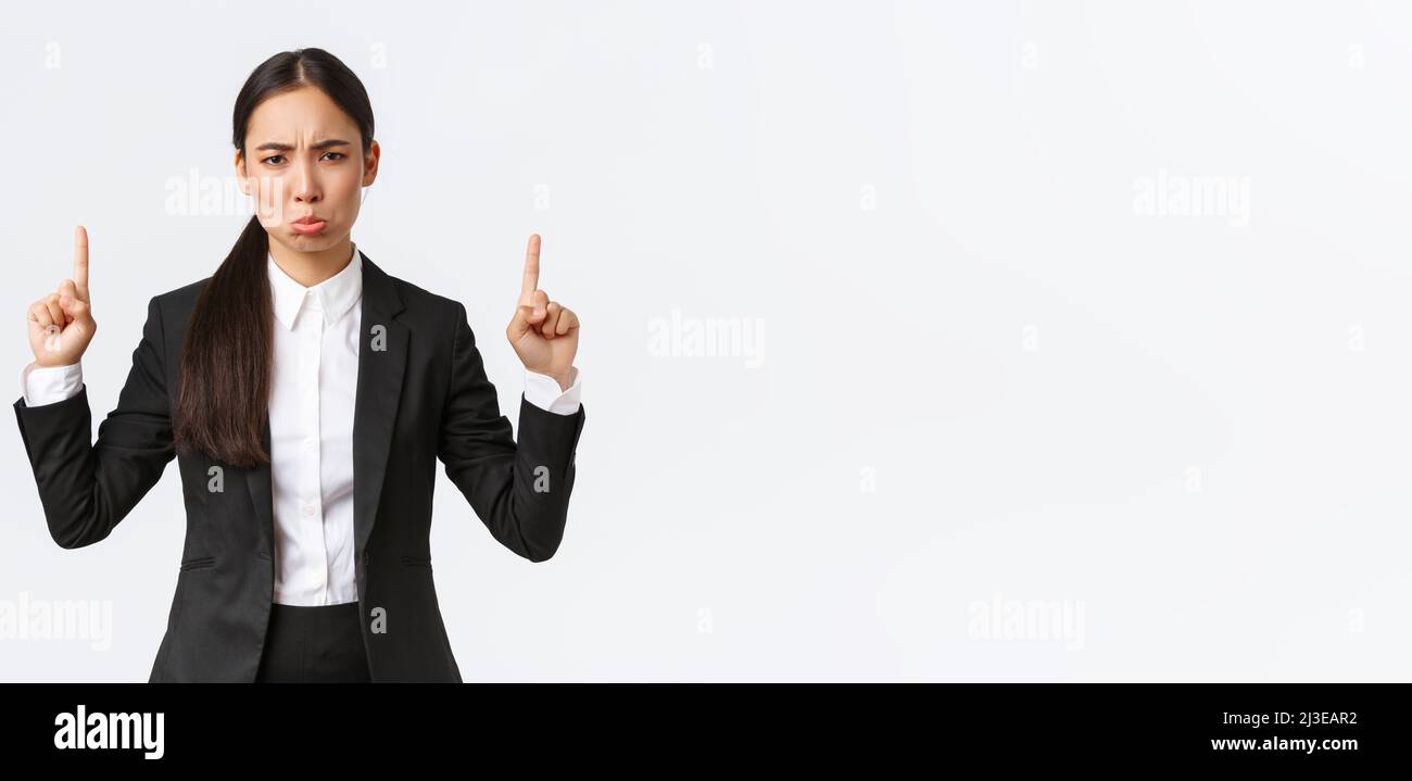 Disappointed pouting asian female entrepreneur in suit complaining and ...