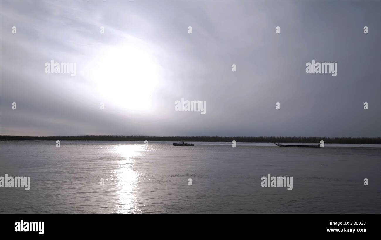 Natural landscape with a river in early winter and the cold sunlight ...