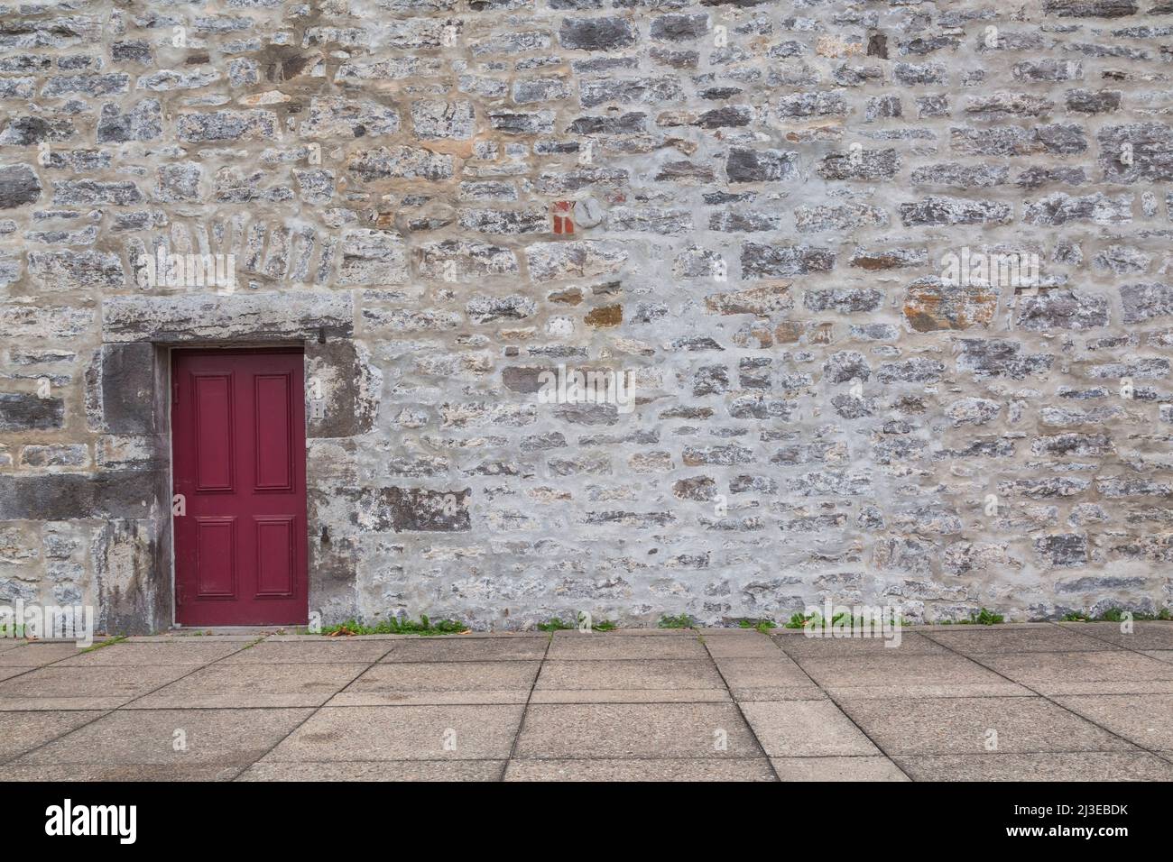 Burgundy coloured entrance door on old fieldstone building, Old ...