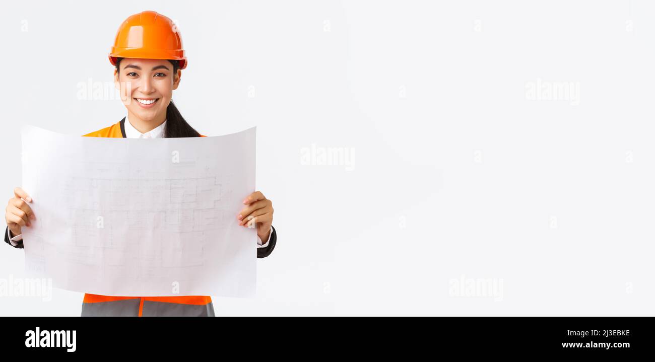 Excited smiling asian female engineer at construction area study ...