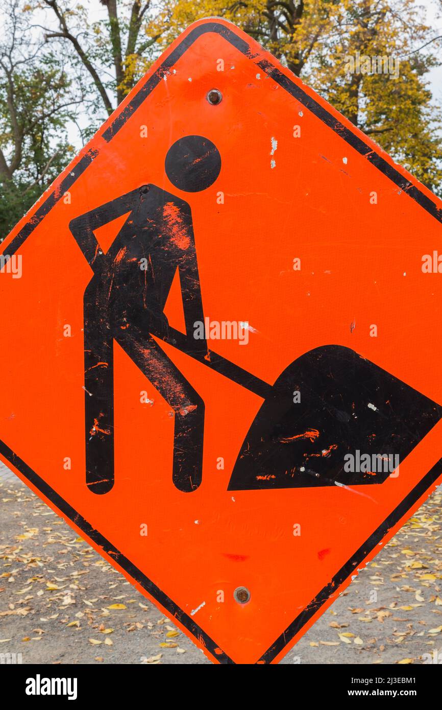Black and orange man at work pictogram sign Stock Photo - Alamy