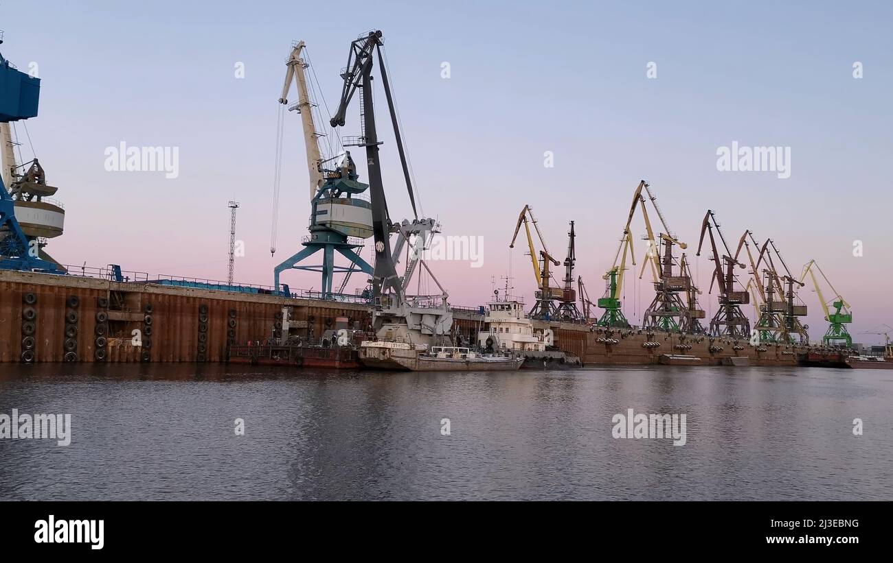 The large cranes at the sea port on sunset sky background. Clip. Big ...