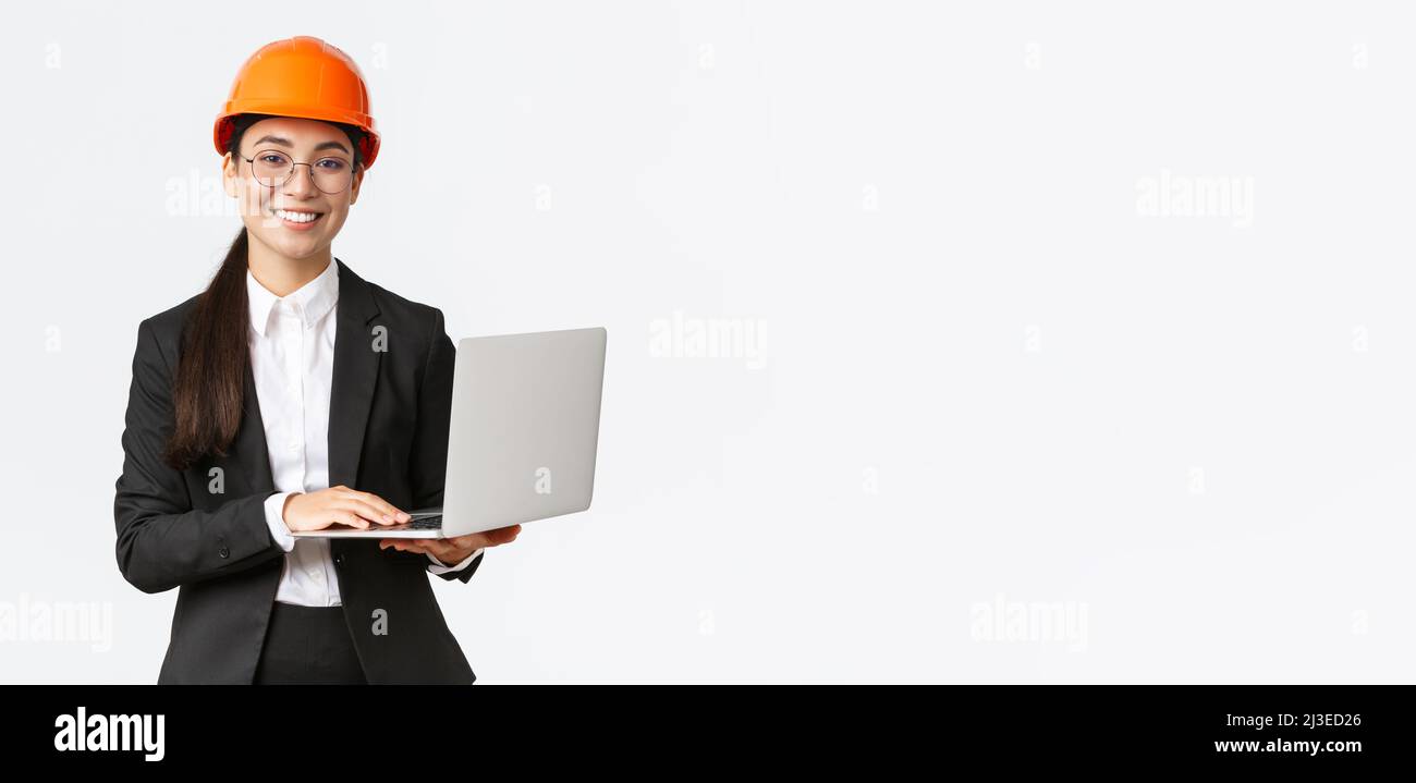 Smiling professional female saleswoman showing construction works on ...