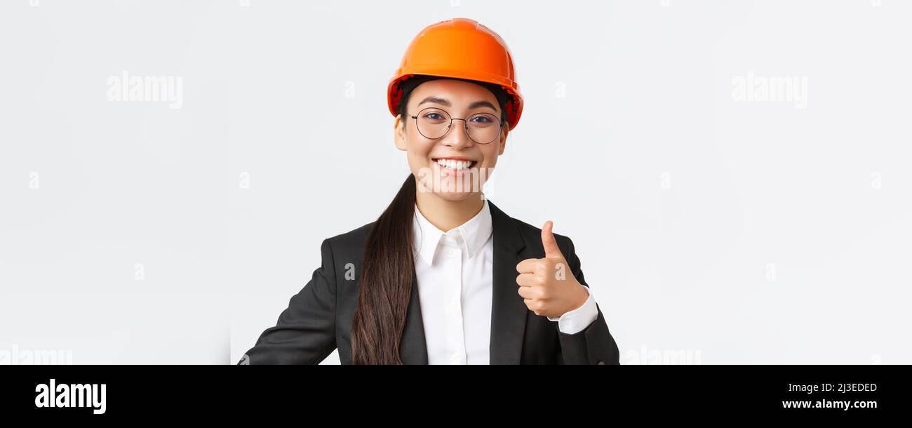Close-up of professional pleased asian female chief engineer, architect ...