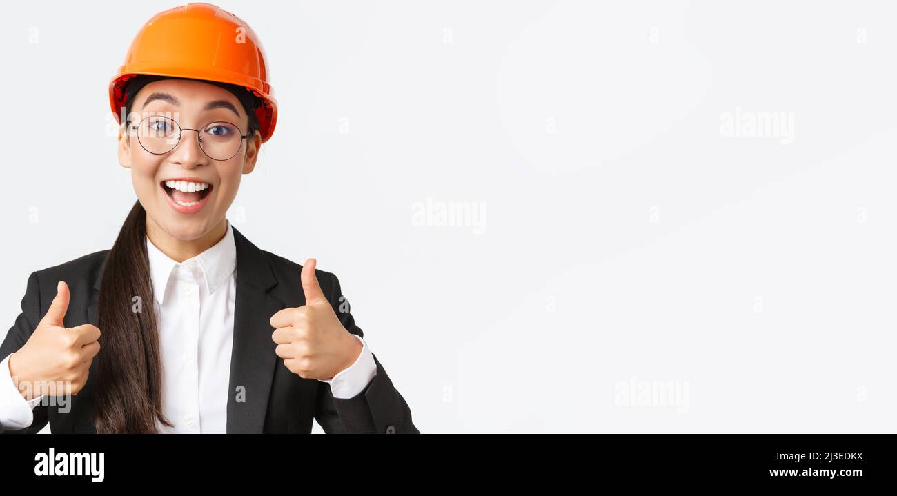 Excited happy female asian engineer, construction manager in safety ...