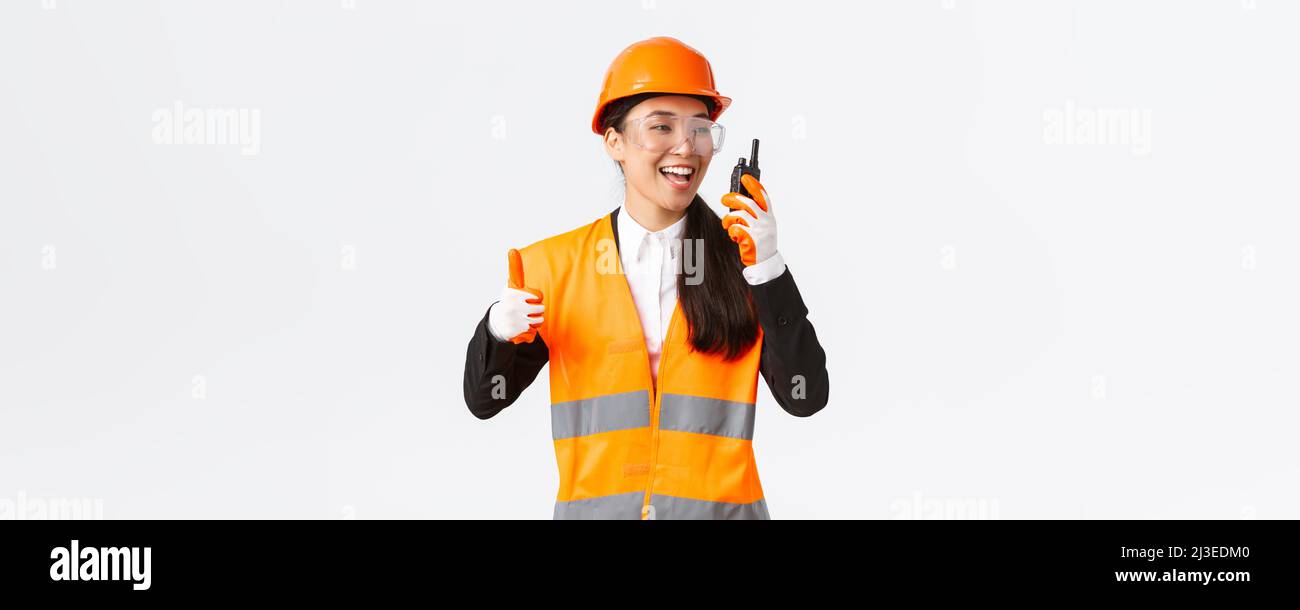 Satisfied happy smiling asian female engineer, industrial technician in ...