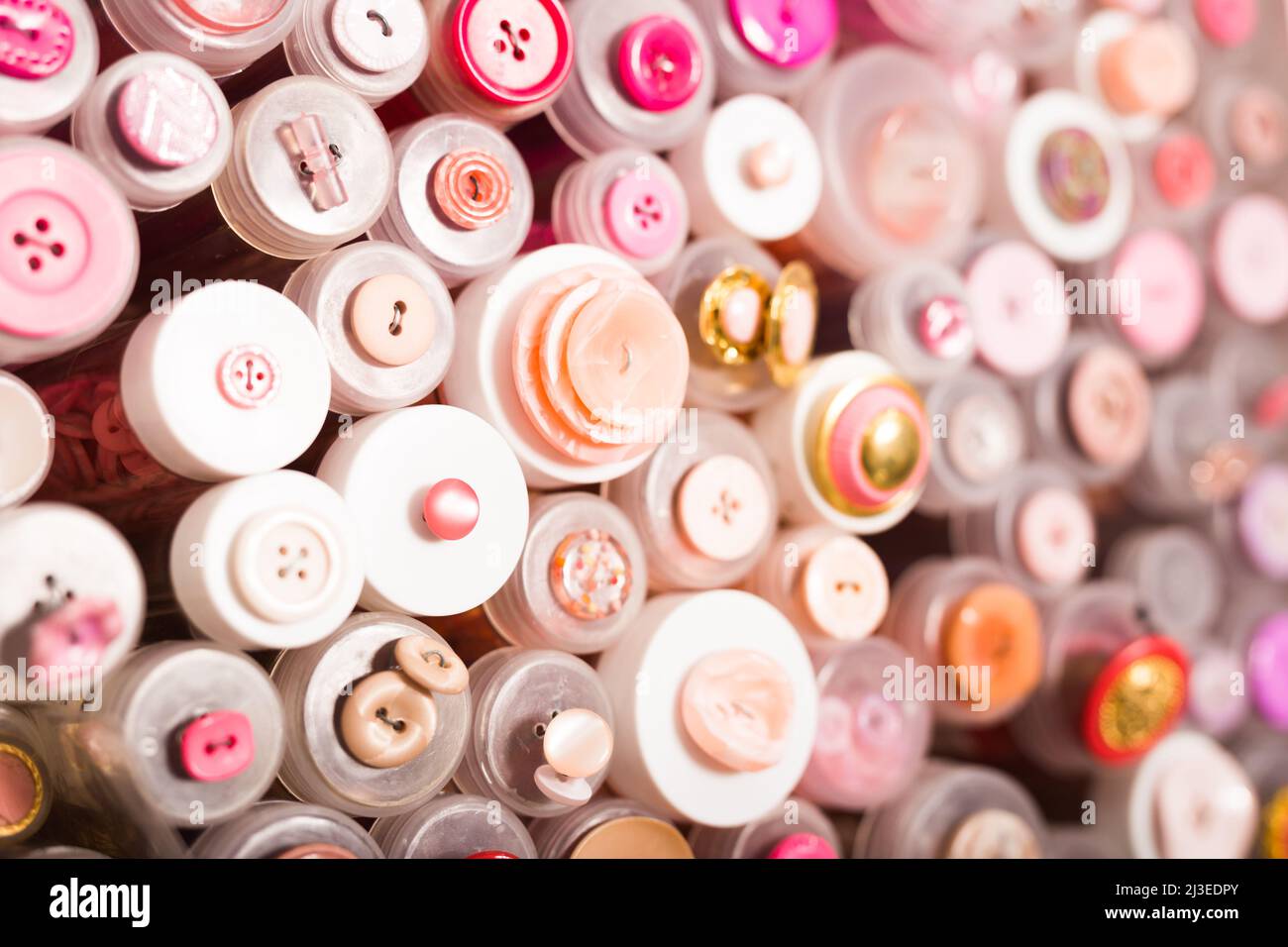 Buttons in plastic containers in store Stock Photo - Alamy