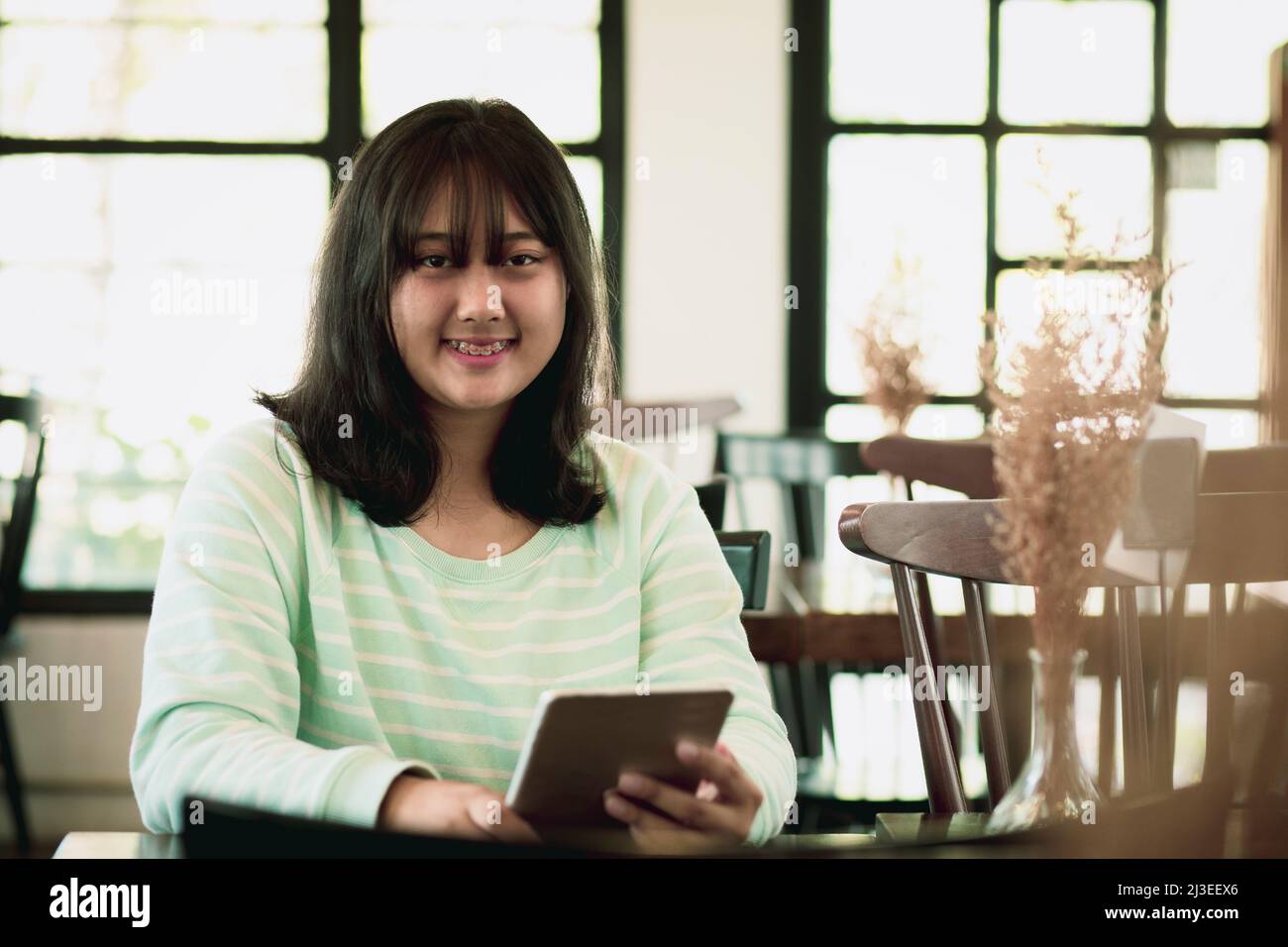 asian chubby girl holding computer tablet in hand Stock Photo - Alamy