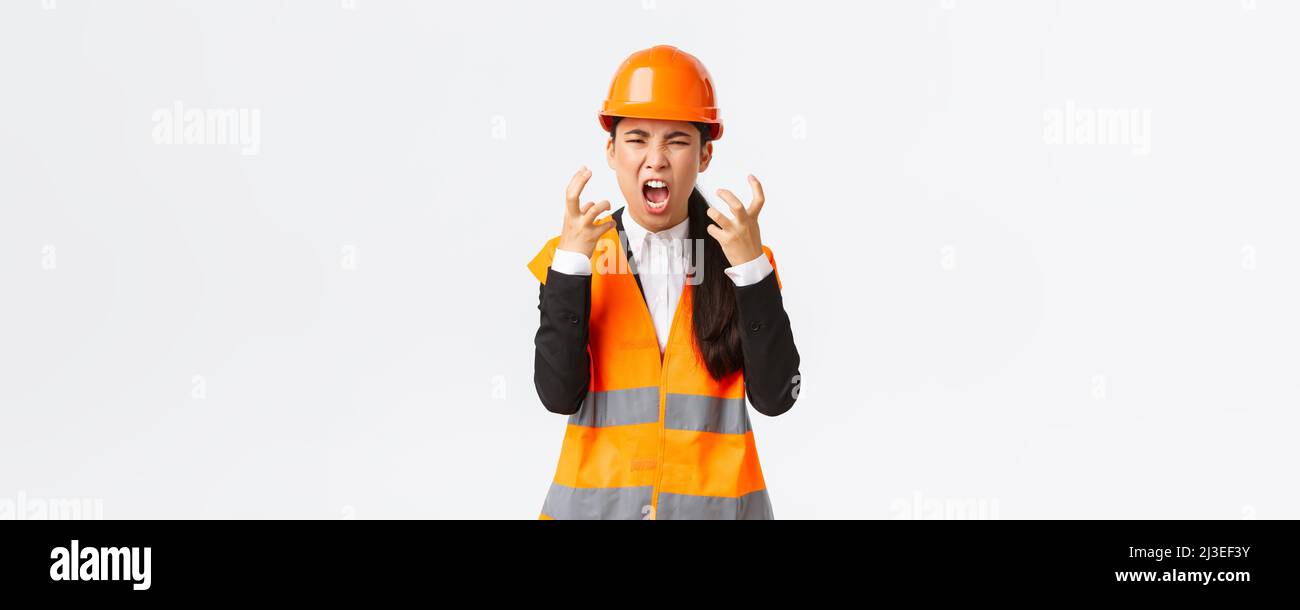 Mad and outraged asian female chief engineer, construction manager ...
