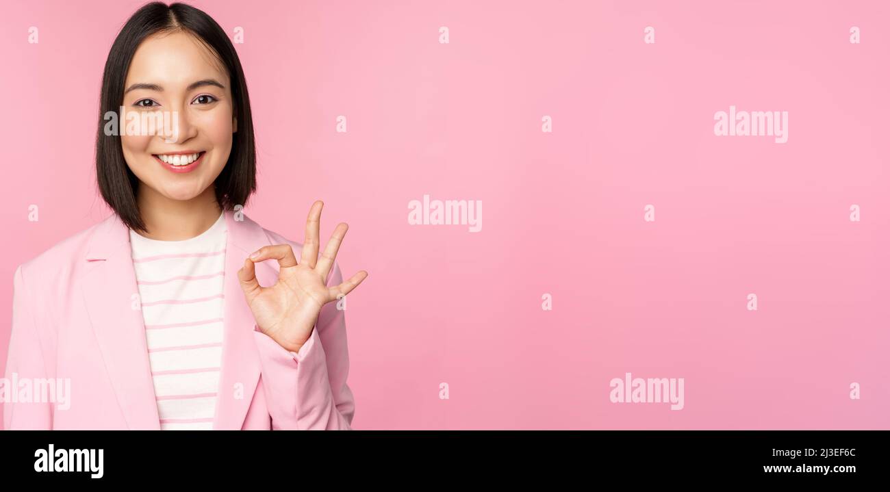 Excellent work, well done gesture. Smiling asian businesswoman showing ...