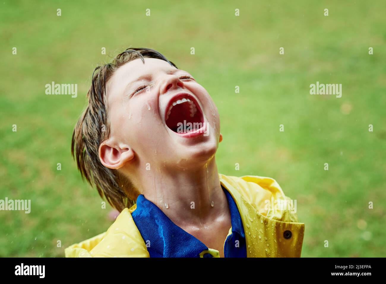 Bring on the rain. Shot of a cheerful little boy standing on his own ...