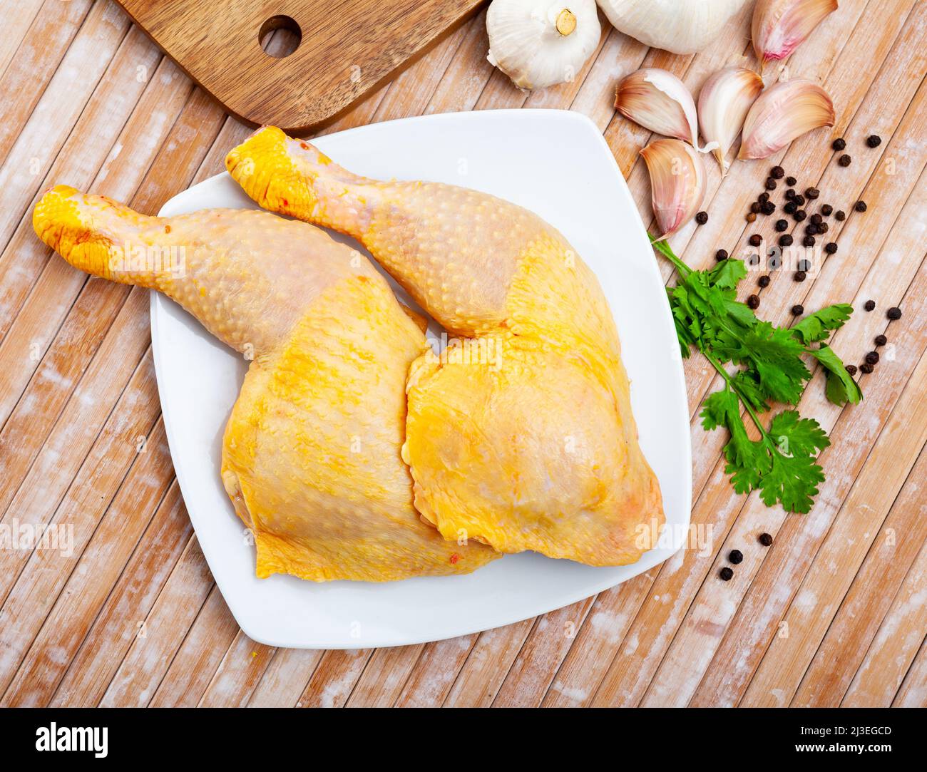 Raw chicken legs with garlic and parsley Stock Photo - Alamy