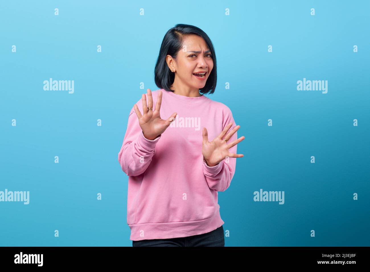 Portrait of beautiful young Asian woman refusing offer feeling awkward ...