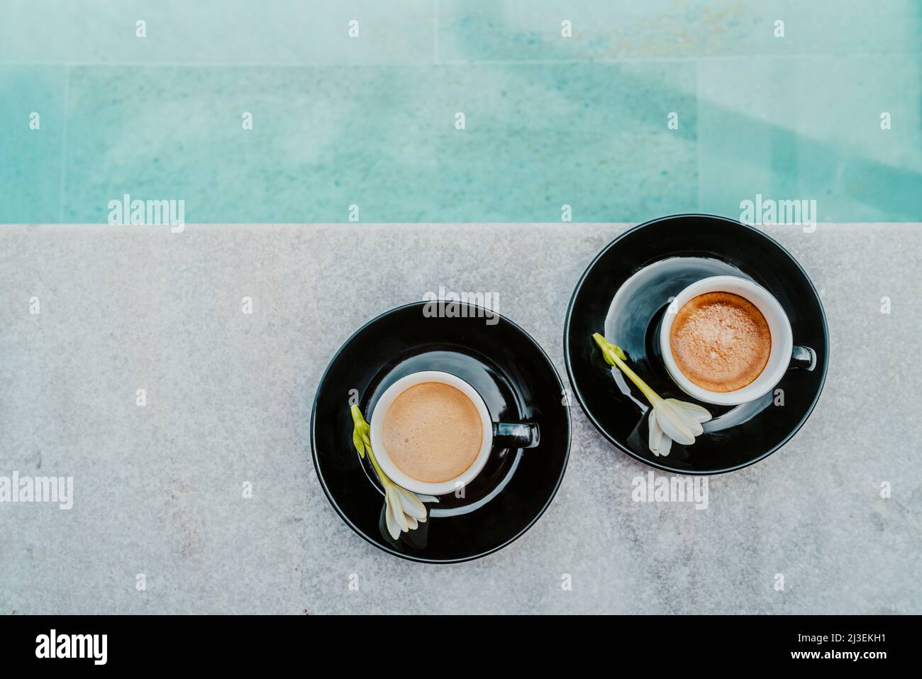Coffee in espresso cups for two people on luxury pool side on vacation ...
