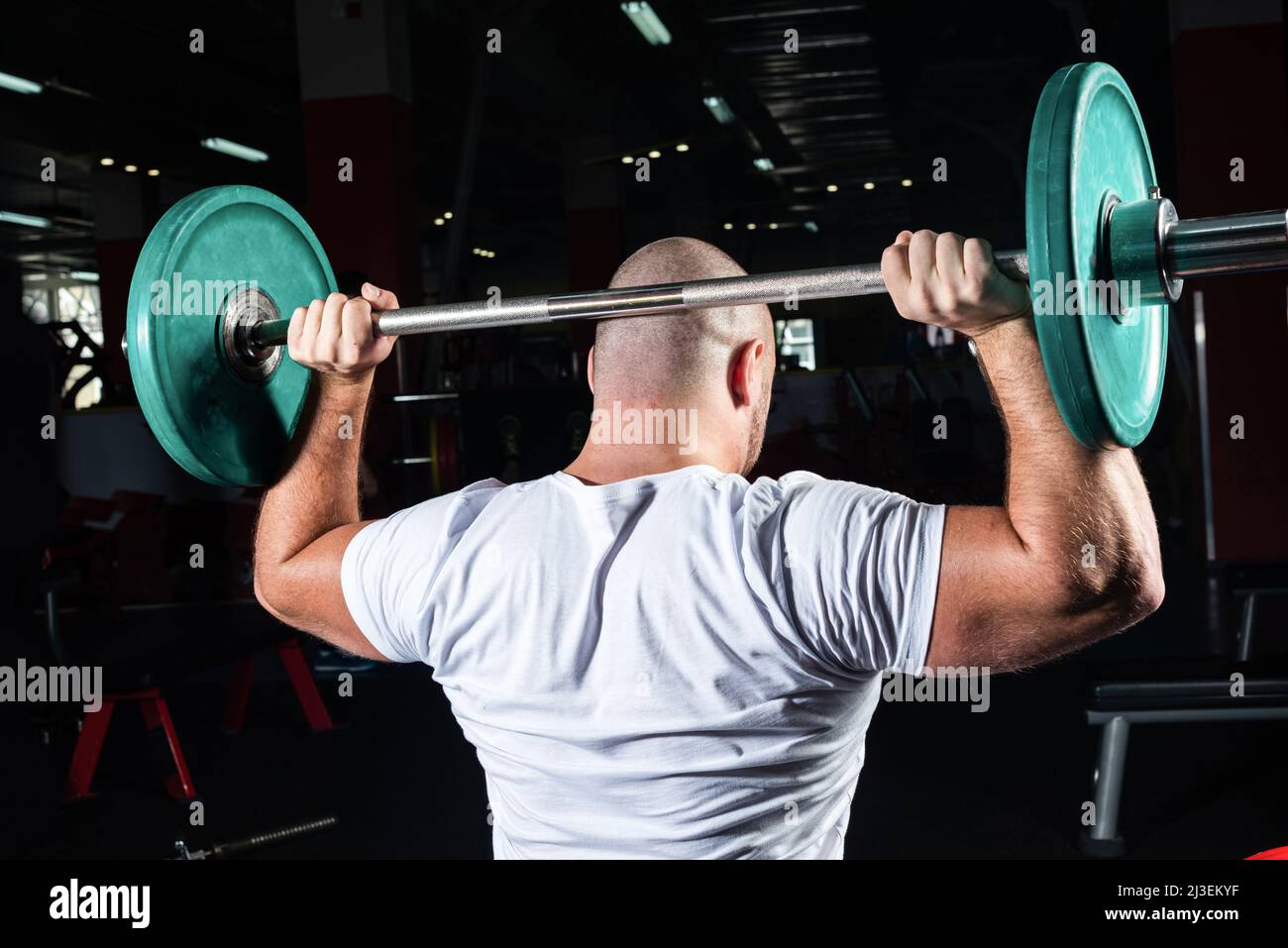 Male athlete lifts the barbell Stock Photo - Alamy