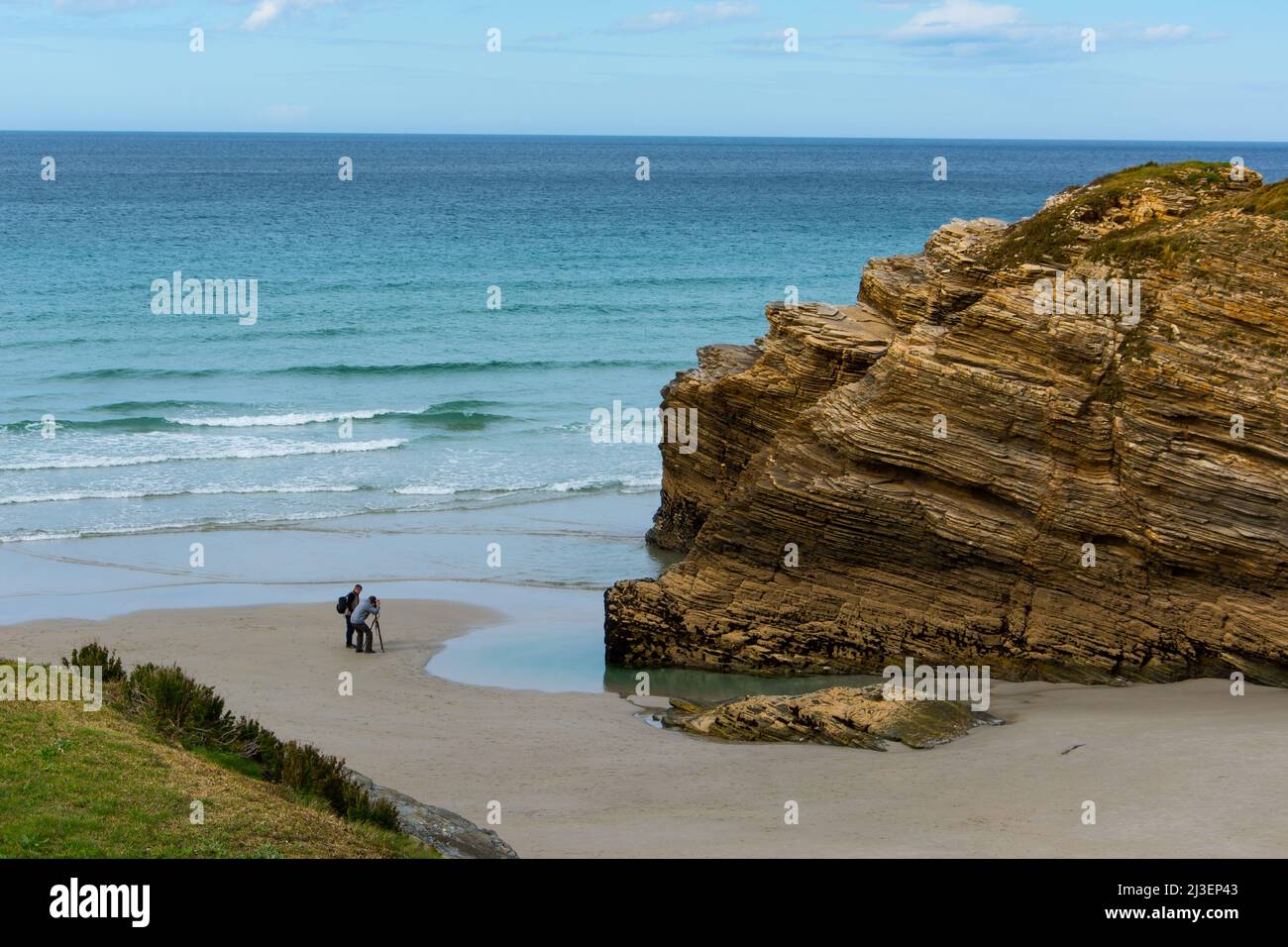 Photographer and assistant working on the shore Stock Photo - Alamy